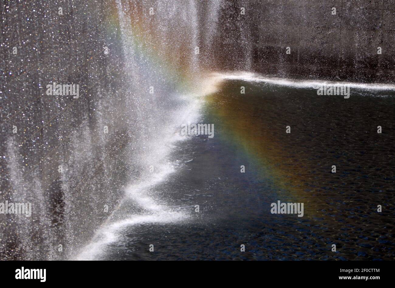 A rainbow appears in the spray of the north pool at the National ...