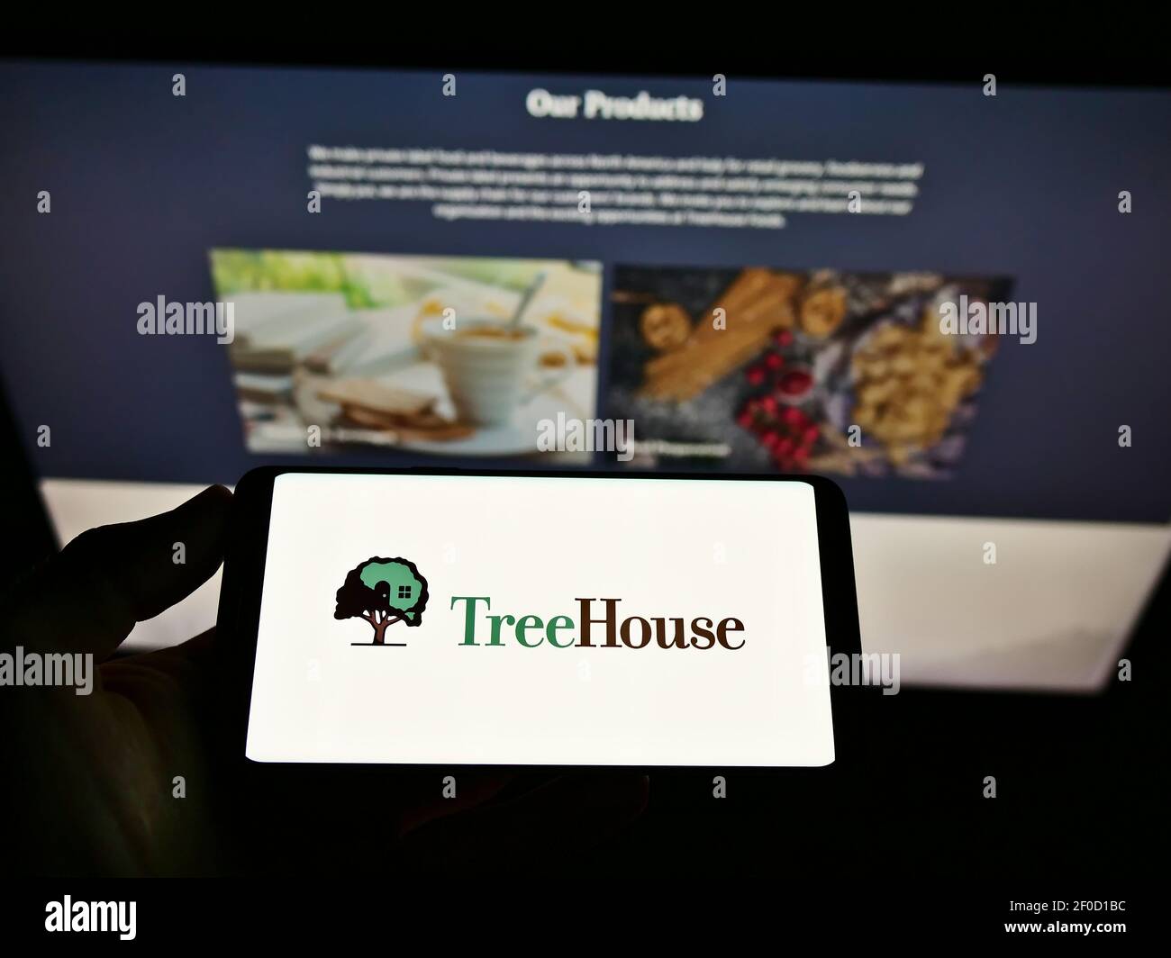 Person holding smartphone with logo of US food processing company ...