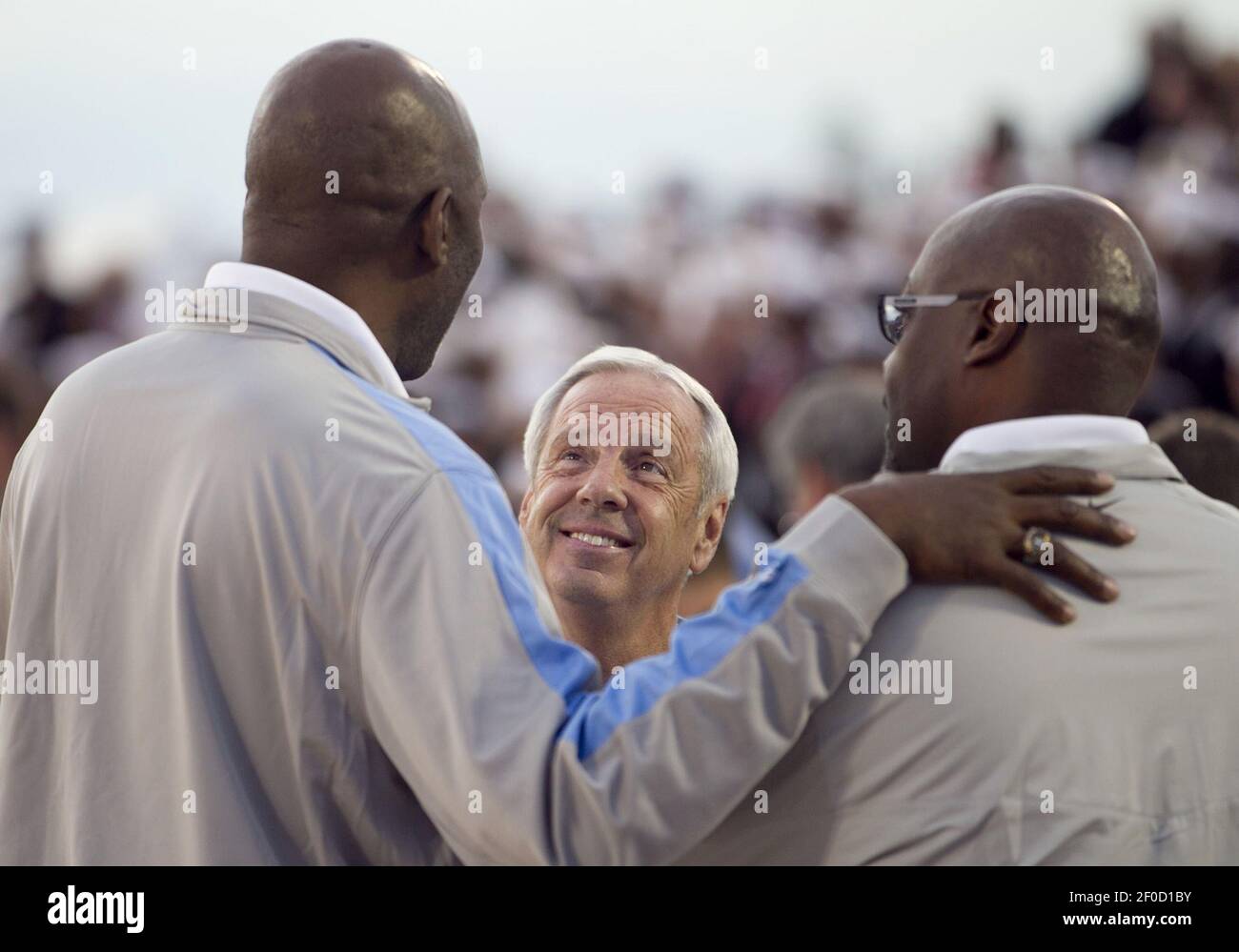 North Carolina coach Roy Williams huddles with former Tar Heel James ...