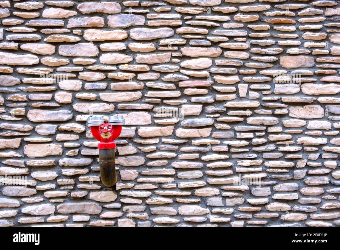 red fireplug at old style stone wall Stock Photo - Alamy
