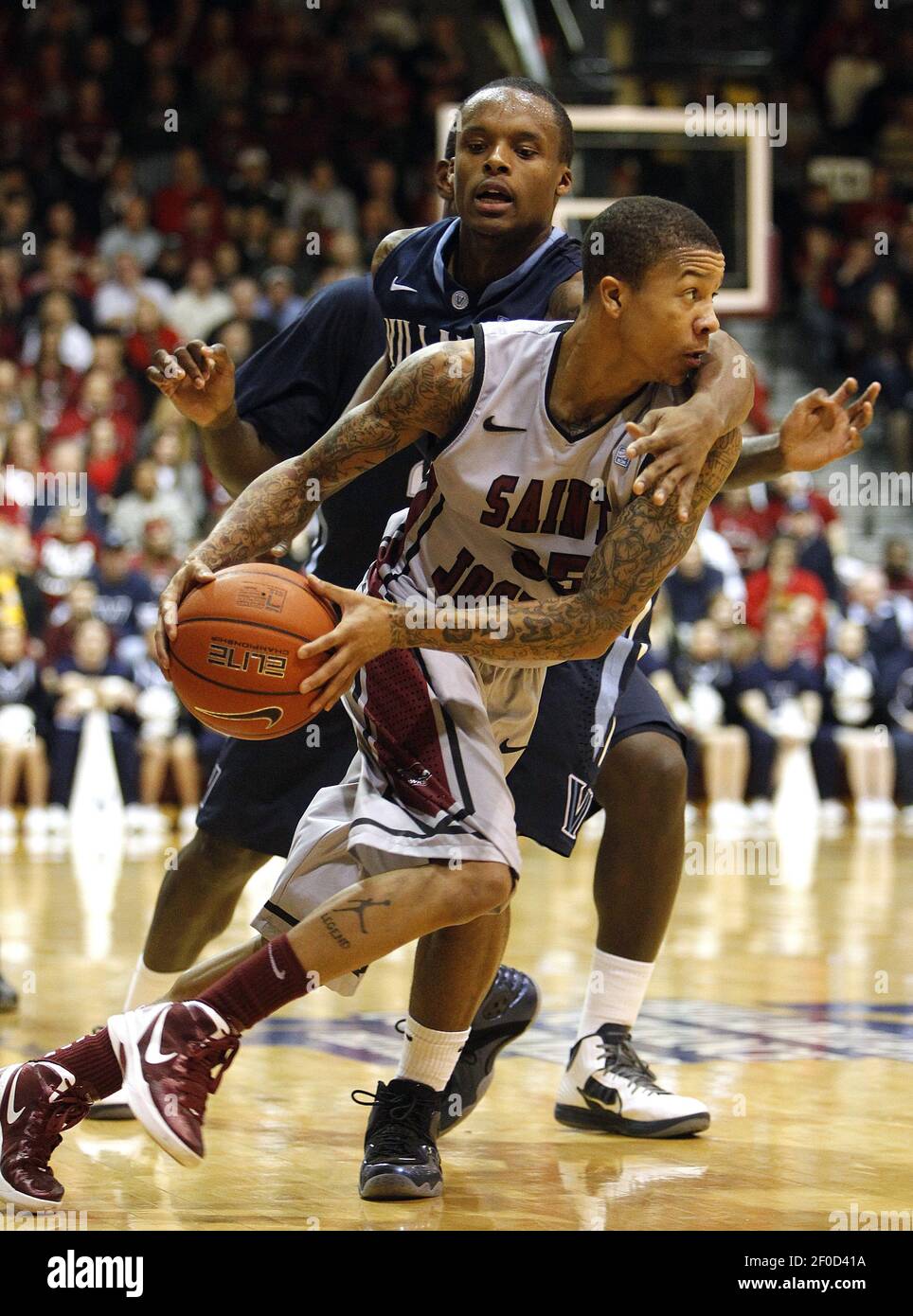 St. Joseph's Carl Jones tries to drive on Villanova defender Maalik ...