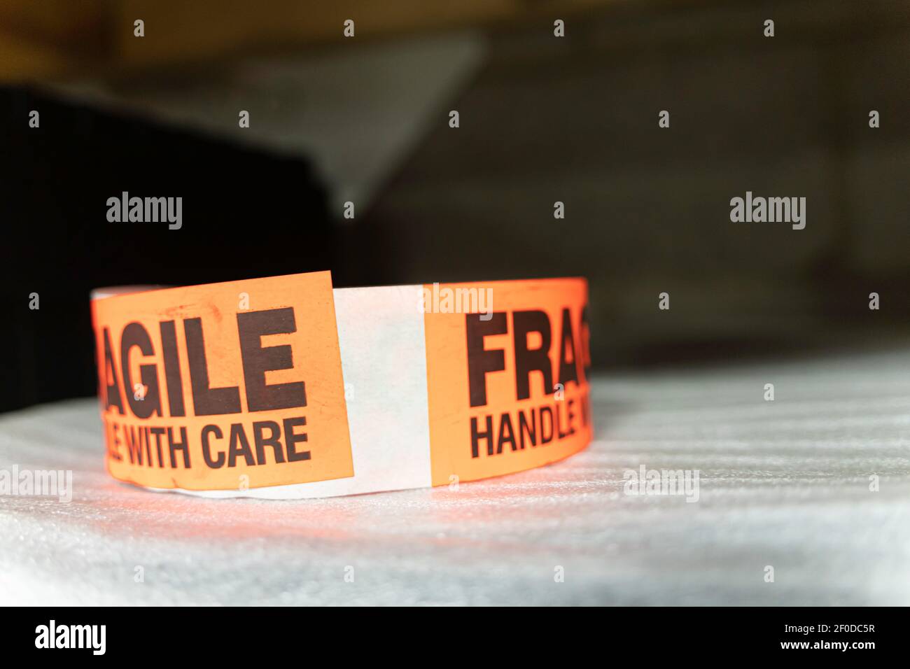 Orange colored shipping label for delivering fragile items Stock Photo ...