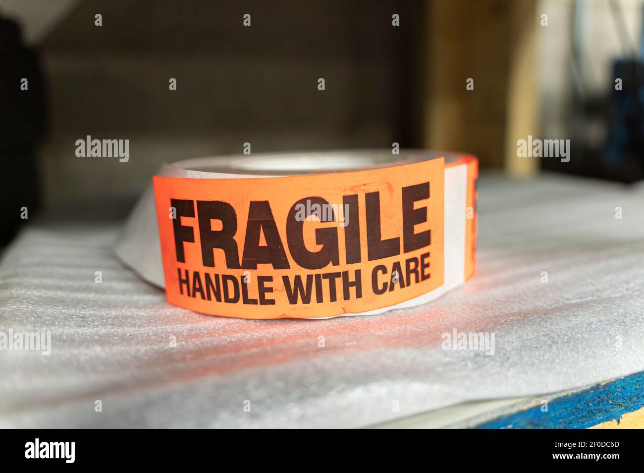 Orange colored shipping label for delivering fragile items Stock Photo ...