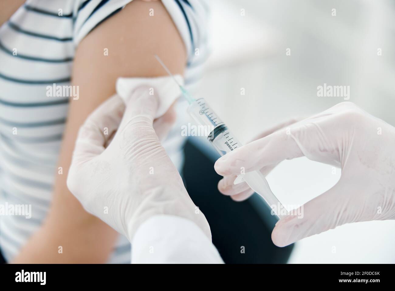 male doctor injections into patient's arm close-up covid vaccination ...