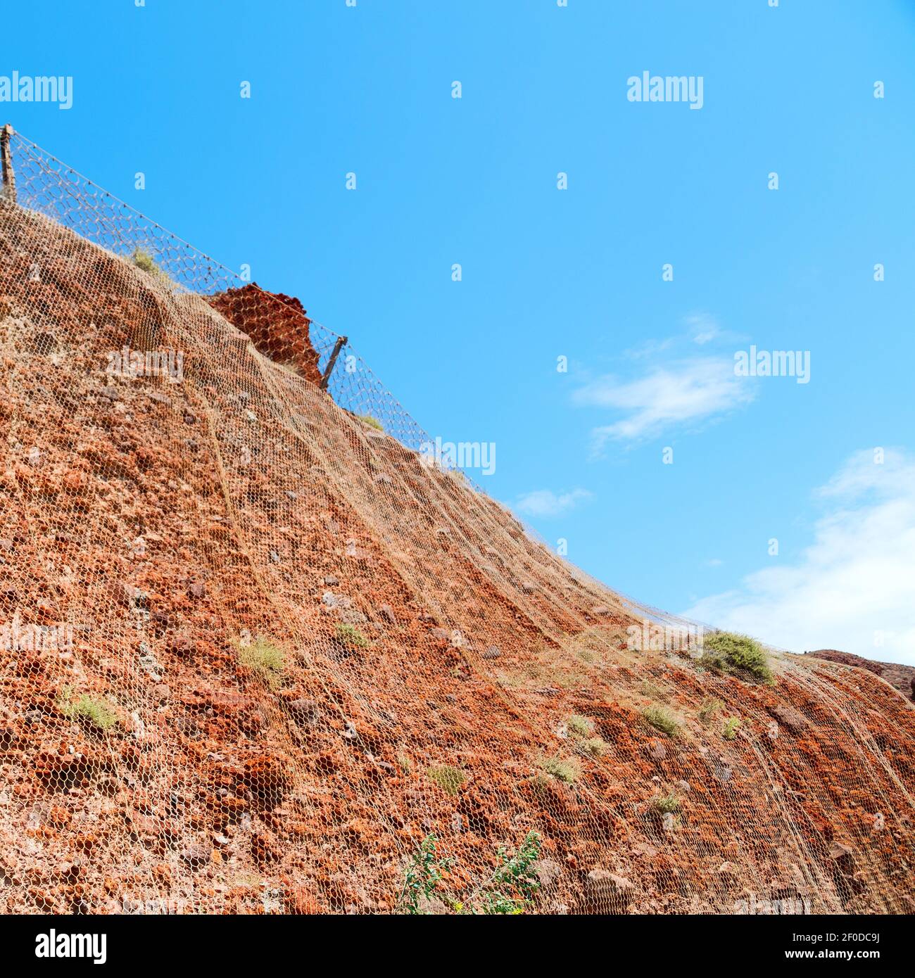 Rock alone in the sky santorini net Stock Photo - Alamy