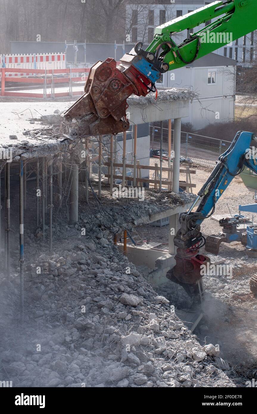 demolition work at a concrete building with excavators with breakers ...