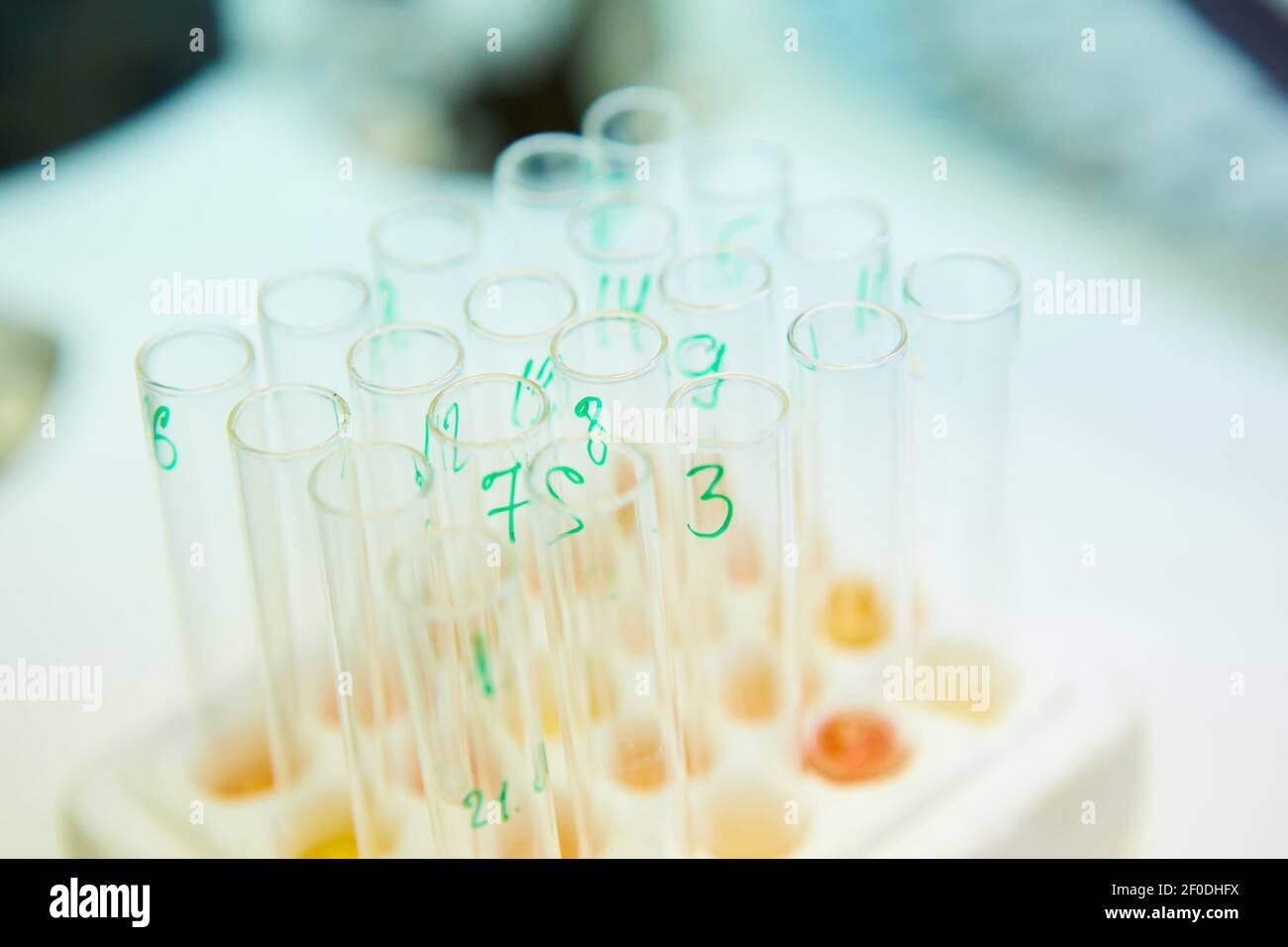 Pipette dropping sample into a test tube,abstract science background ...