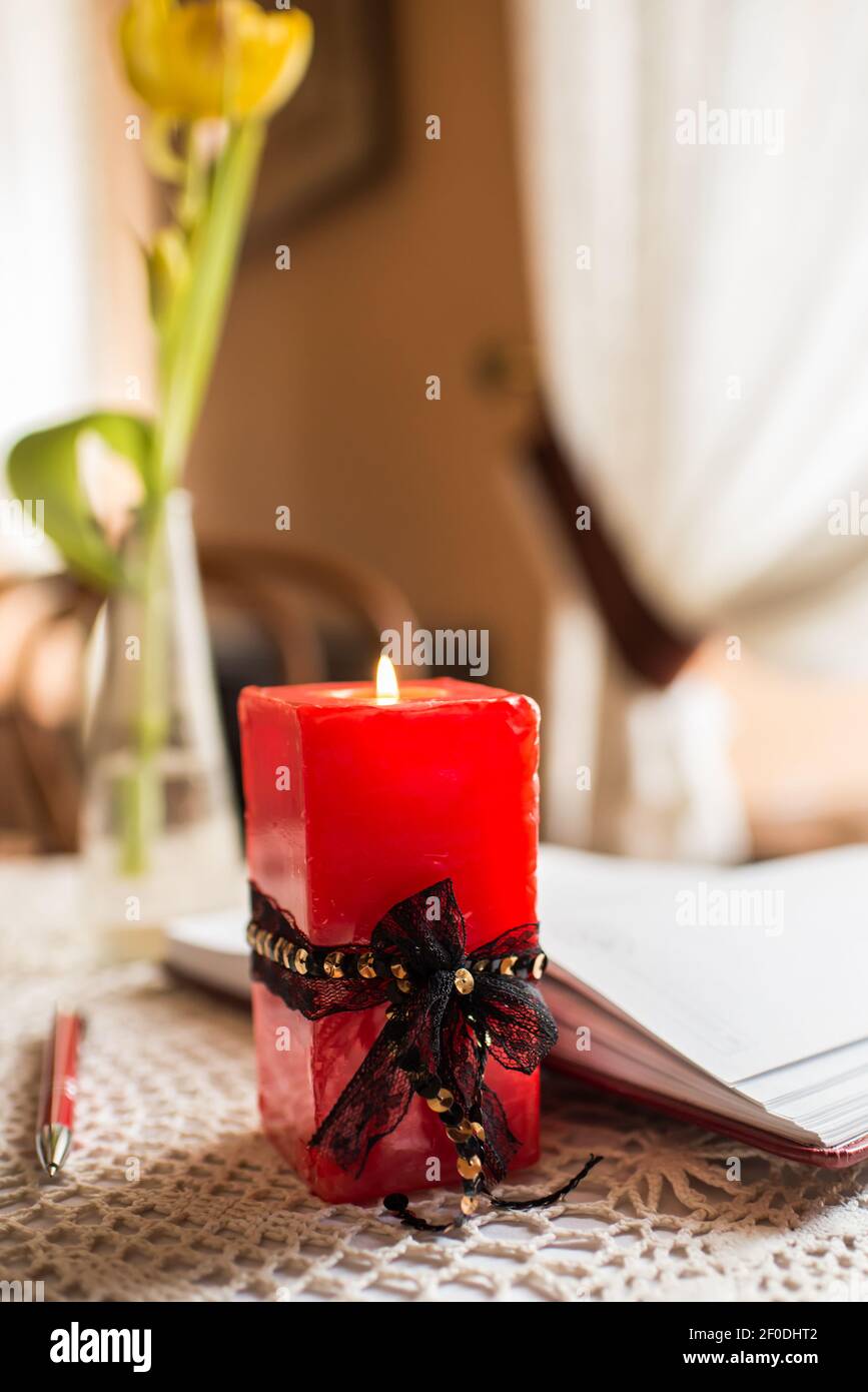 Candle, open book, pen Stock Photo - Alamy