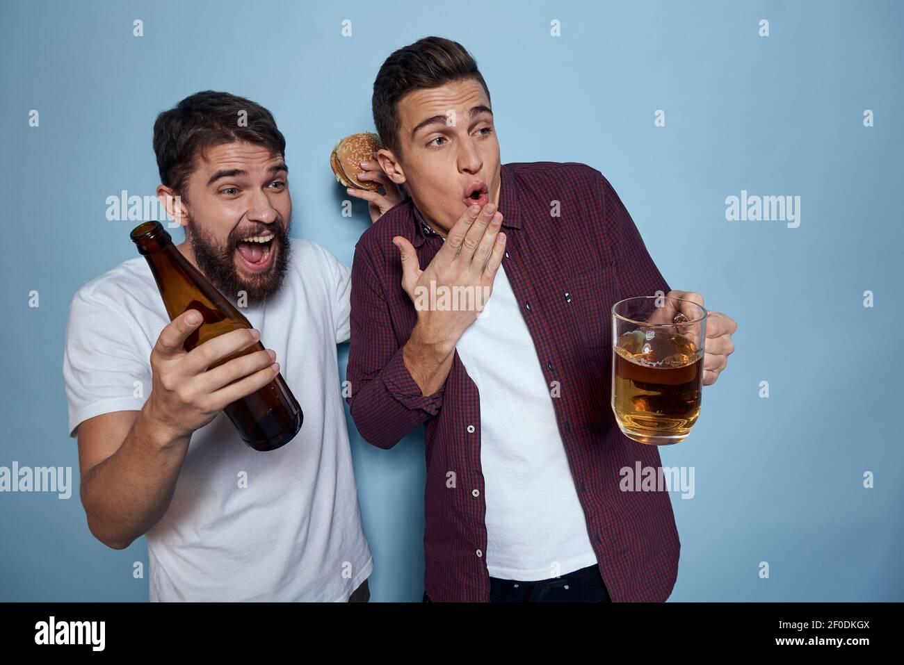 two friends with beer fun entertainment lifestyle blue background Stock ...