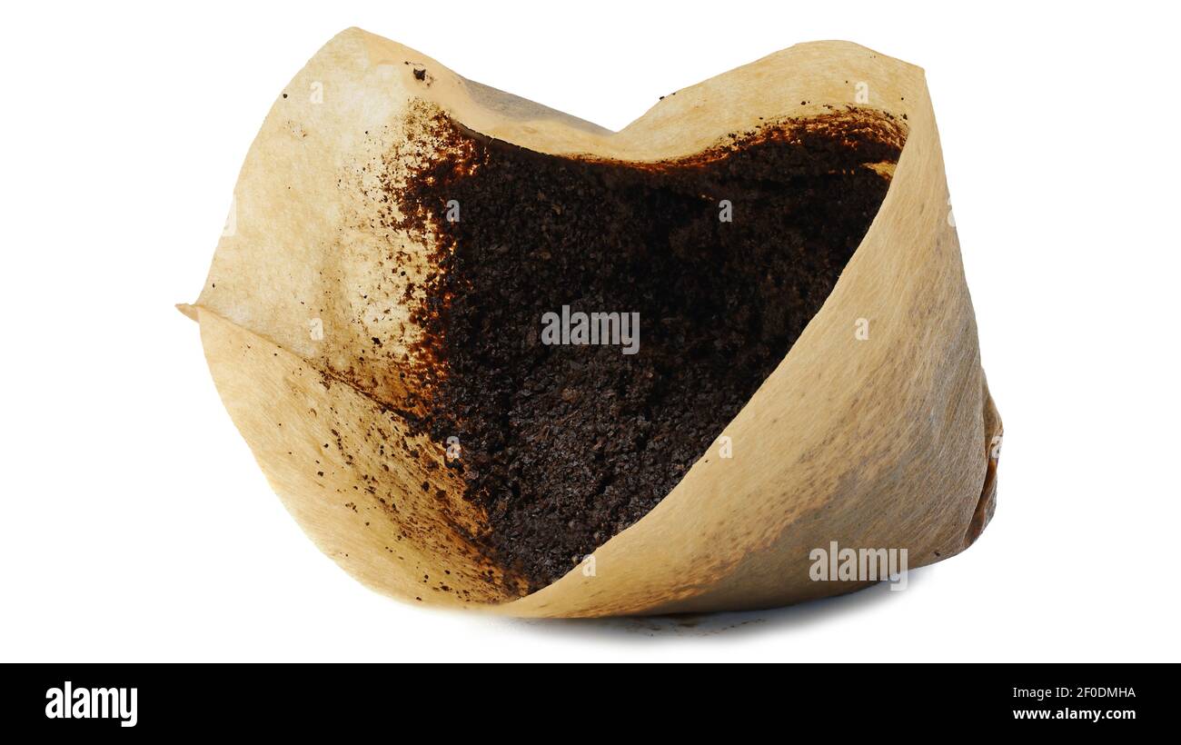 Used ground coffee in a filter isolated on white background, side view ...