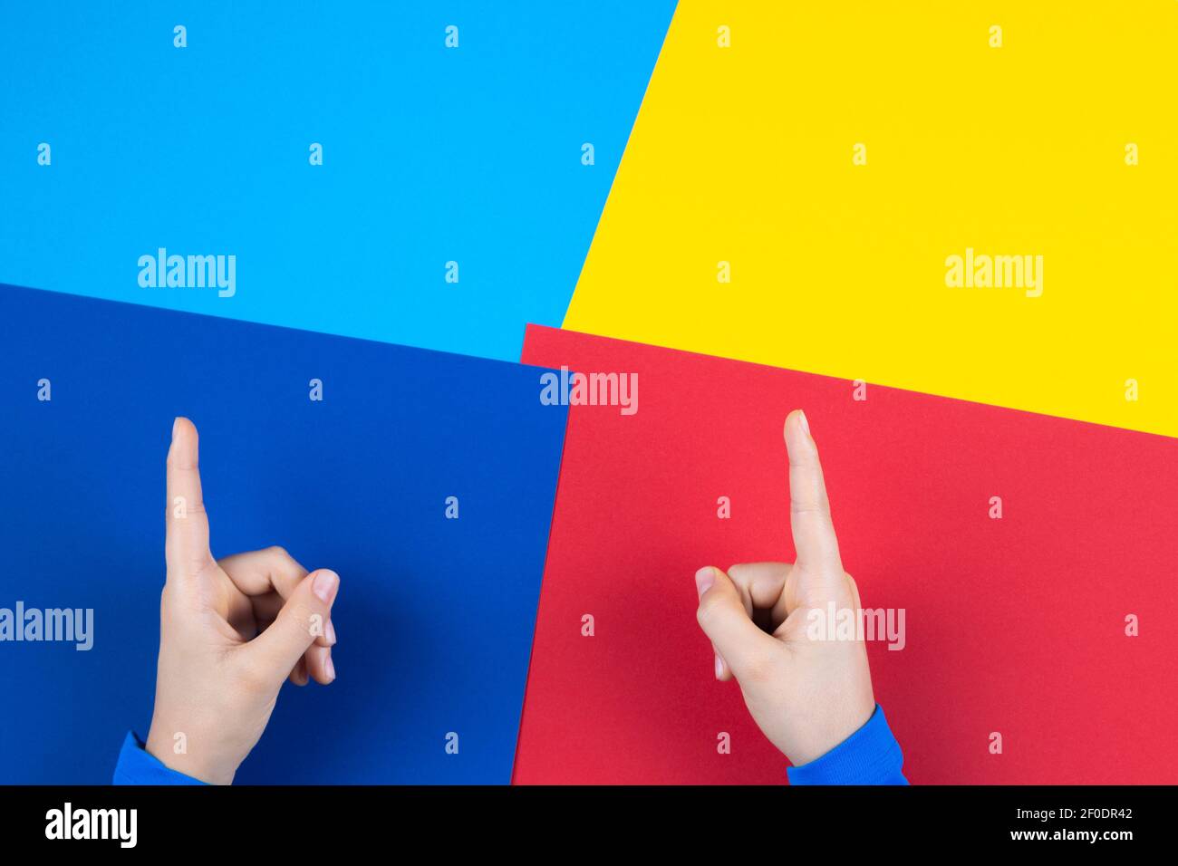 Kid hands fingers pointing up on colorful background Stock Photo - Alamy