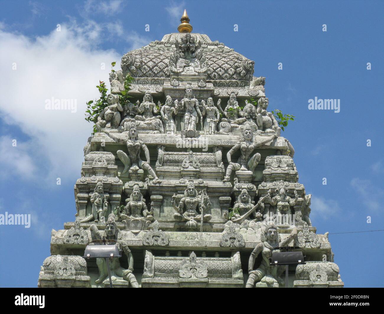 Sculptures of Hindu Gods on top of Hindu temples with blue sky and ...