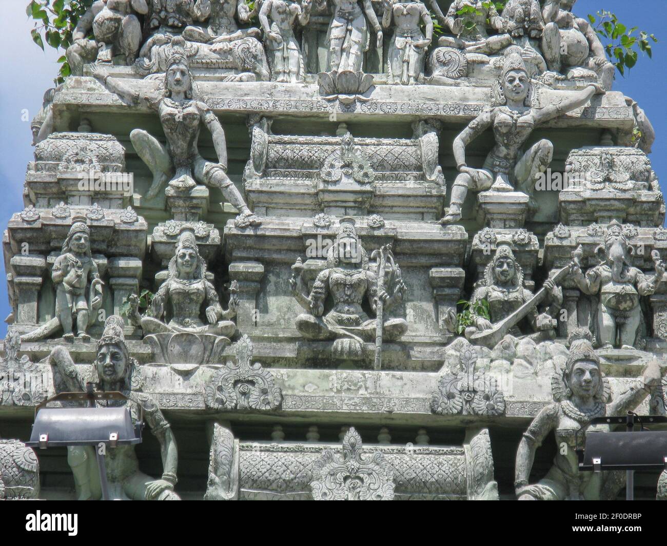 Sculptures of Hindu Gods on top of Hindu temples with blue sky and ...