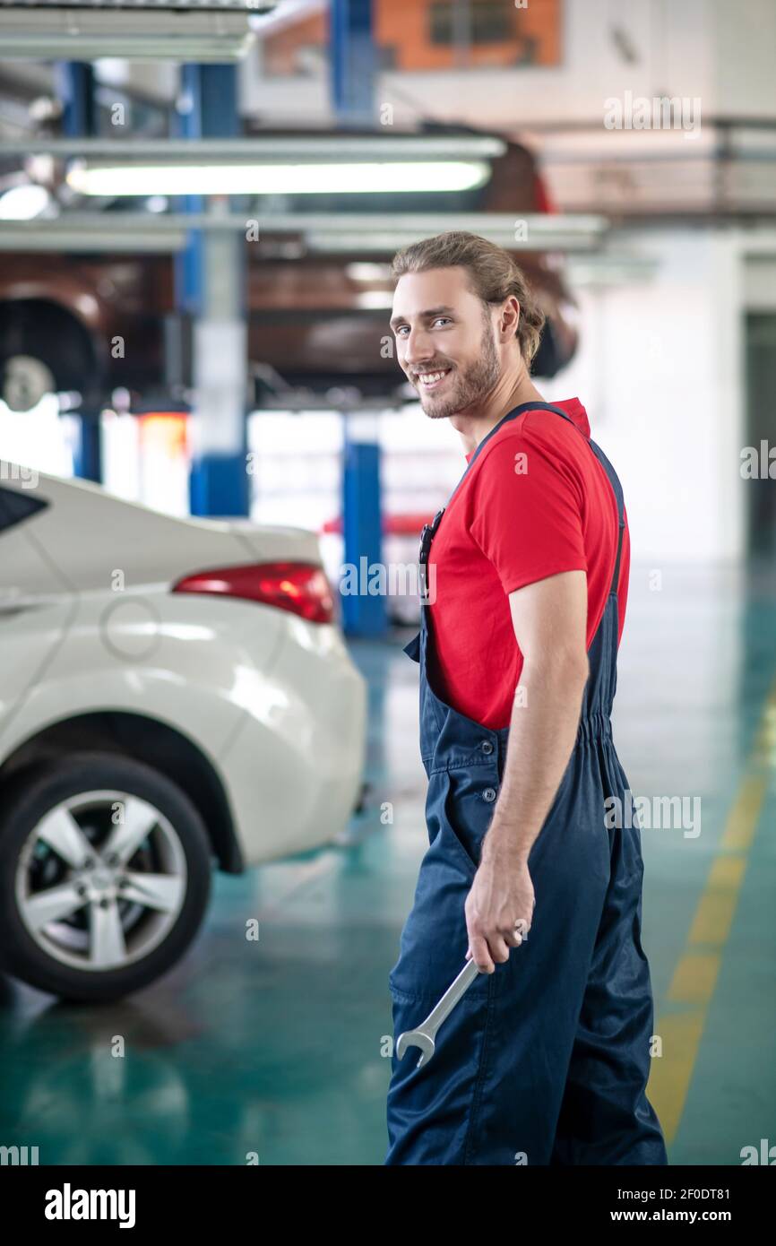 Man with wrench at an auto service station Stock Photo - Alamy