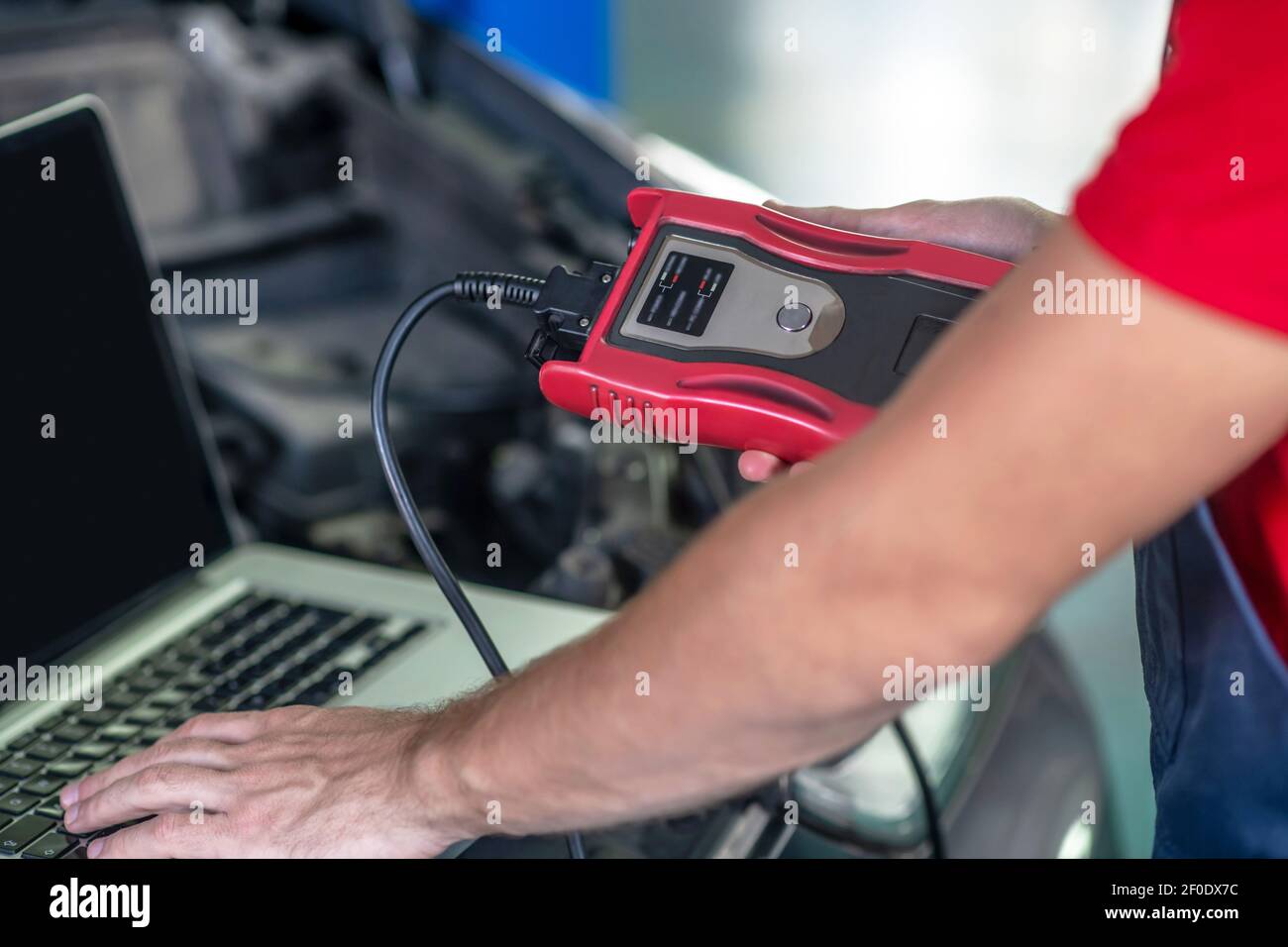 Male hands conducting car diagnostics using computer Stock Photo - Alamy