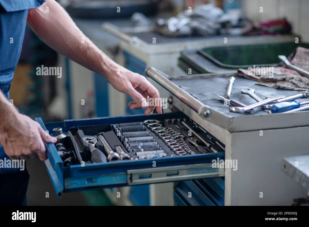 Male hands opening box with working tool Stock Photo - Alamy