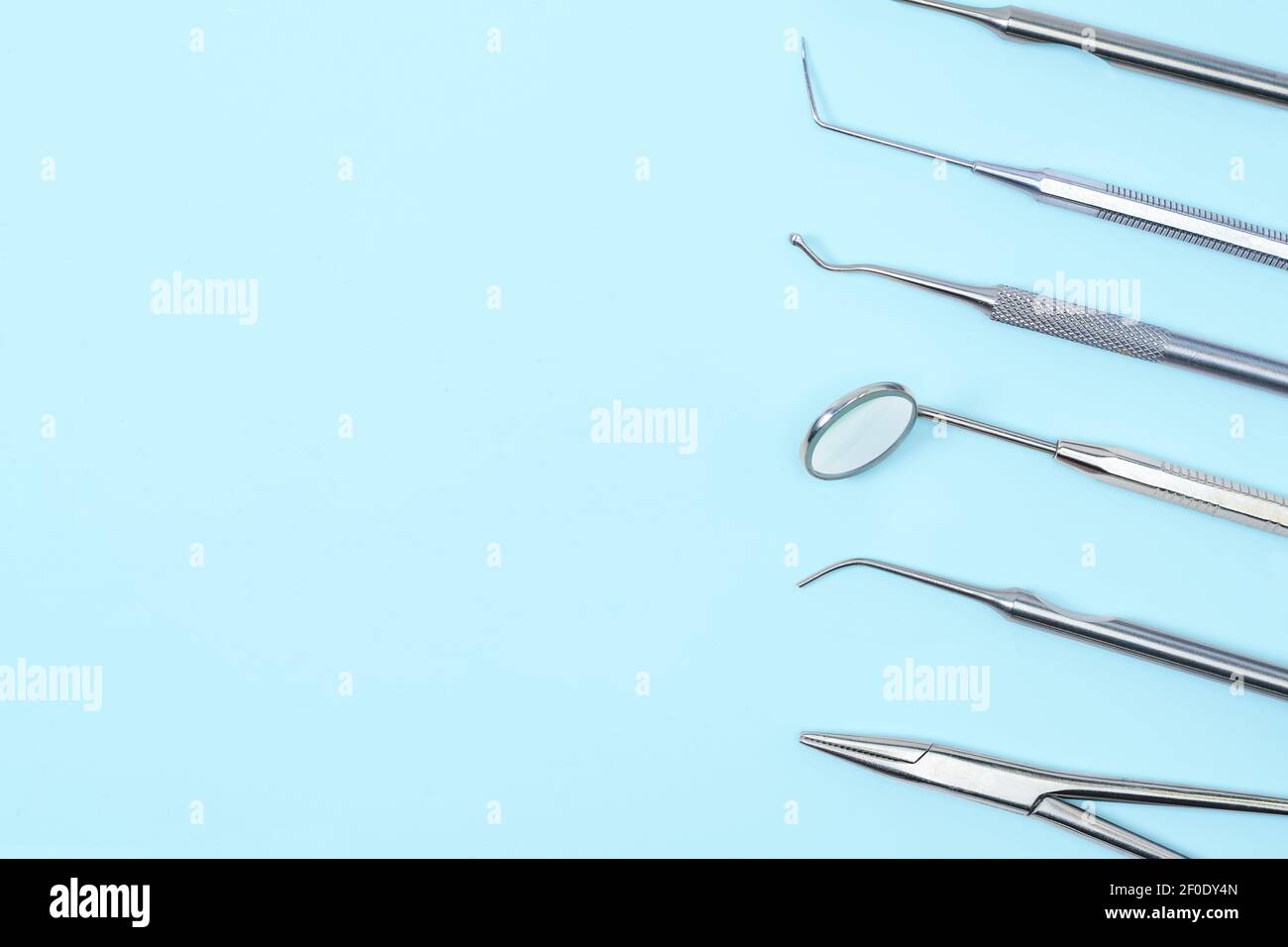 Dentist tools on light blue background: kornzange, curette, dental ...