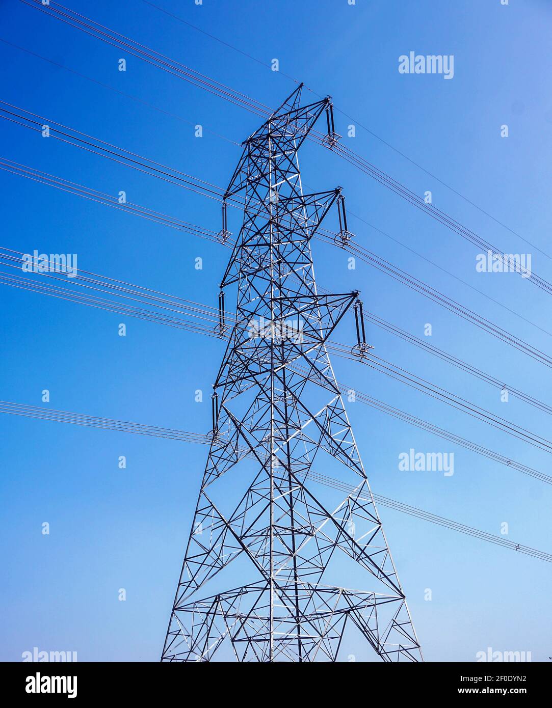 High voltage transmission towers line Stock Photo - Alamy