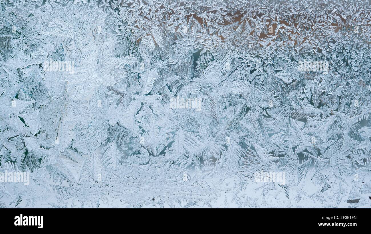 Abstract view of frost on the window surface. Blue crystal frosty ...