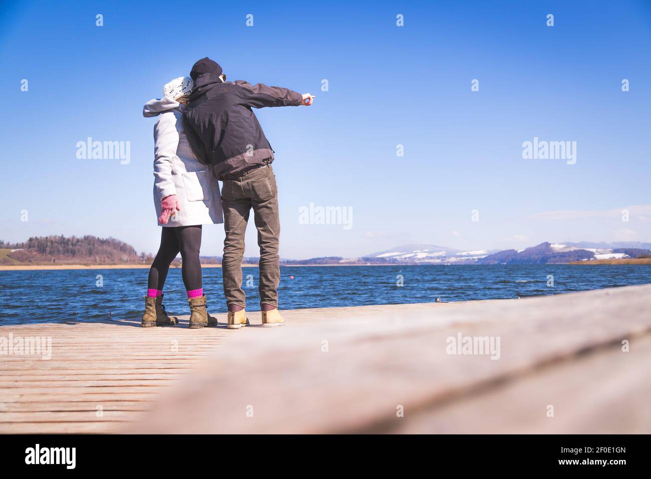 Young couple is standing on a footbridge and enjoys the view over the ...