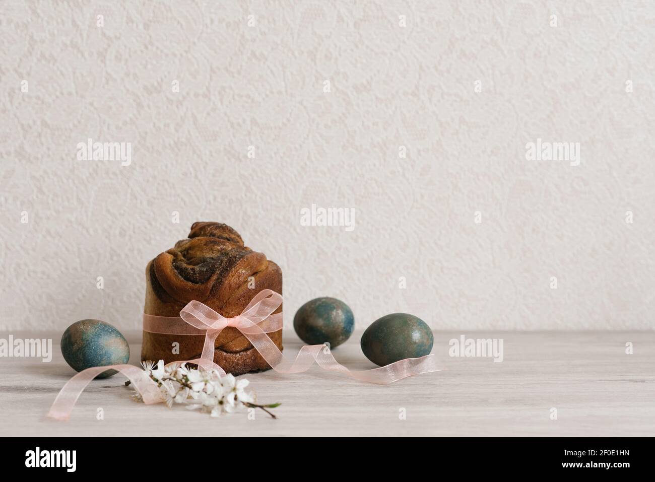 Easter cake and marble blue painted eggs, white flowers, festive ...