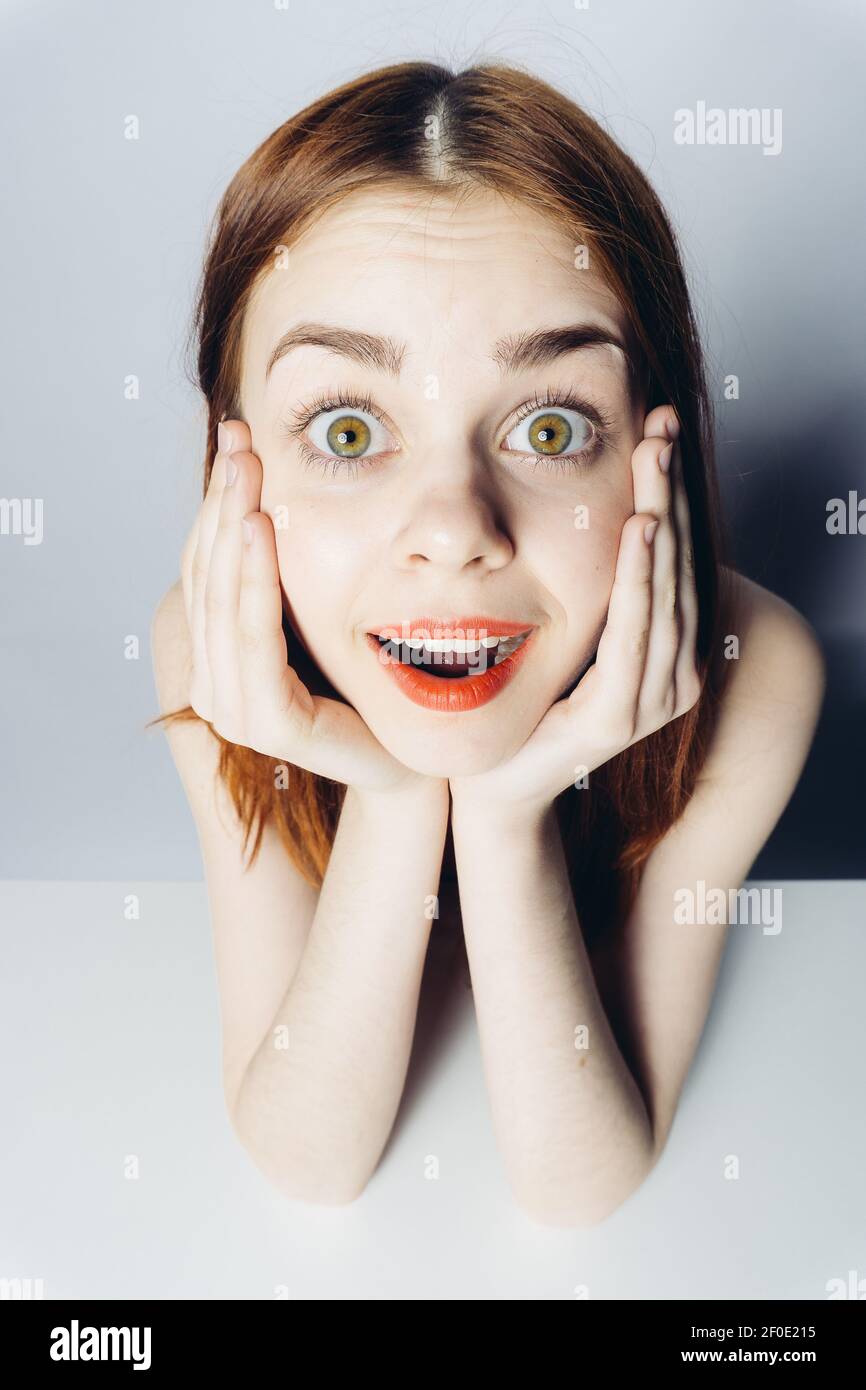 woman with wide open eyes holding hands on face emotions close-up Stock ...