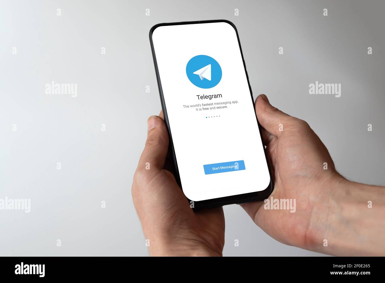 Woman hand holding social networking service with Telegram on screen ...