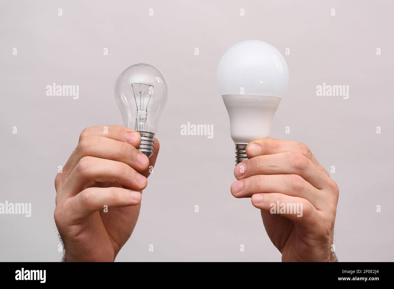 Incandescent light bulb and LED light bulb in your hands Stock Photo ...