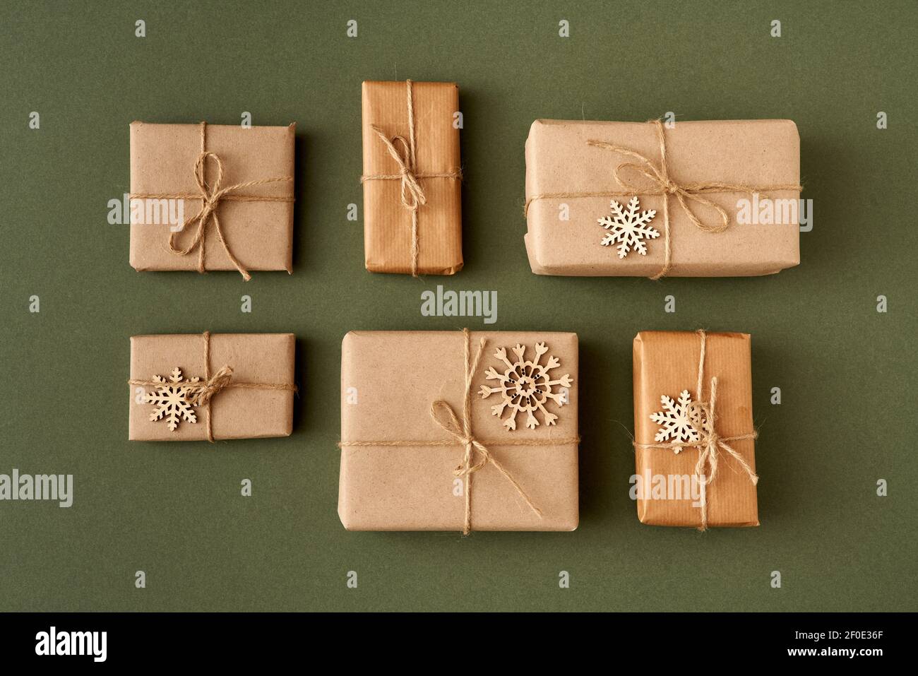 Christmas presents wrapped in ecological recycled paper with wooden ...