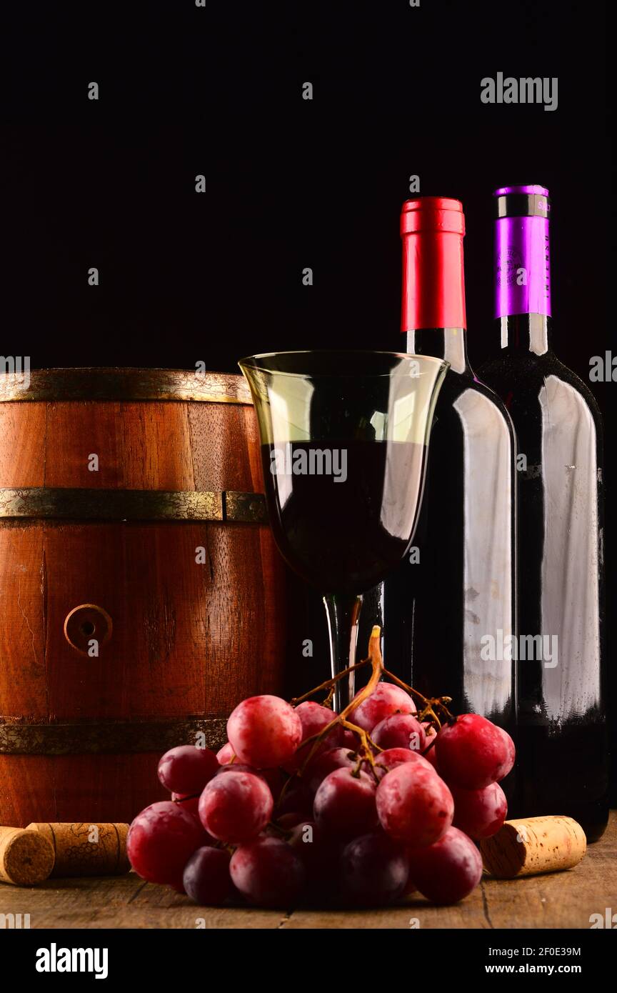 Glass of wine, bottle and wooden barrel nearby Stock Photo - Alamy