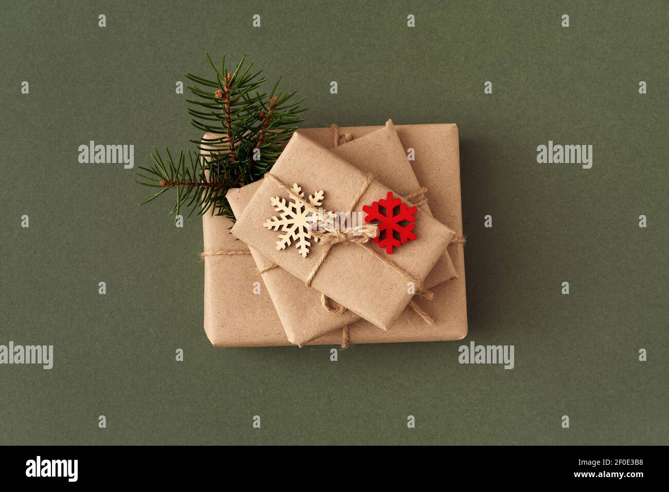 Christmas presents wrapped in ecological recycled paper with wooden ...