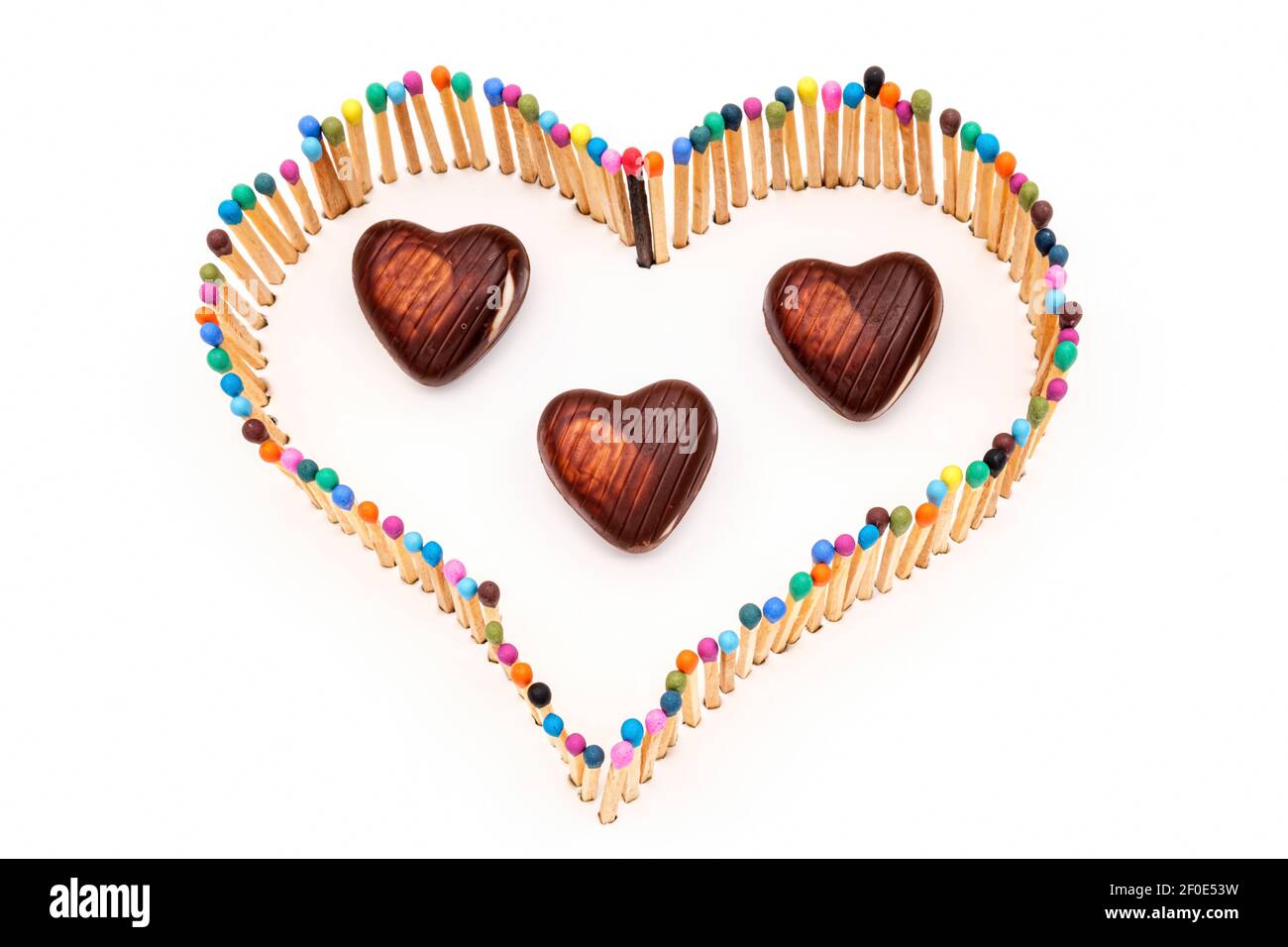 a heart shape made of multicolored matchsticks with heart-shaped ...