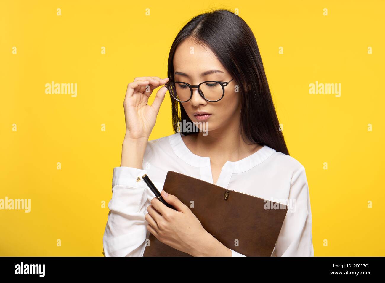 woman holding notepad secretary office yellow background Stock Photo ...