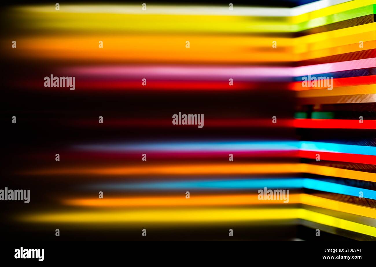 light through Stack of different colours Cast Acrylic Sheet on black ...
