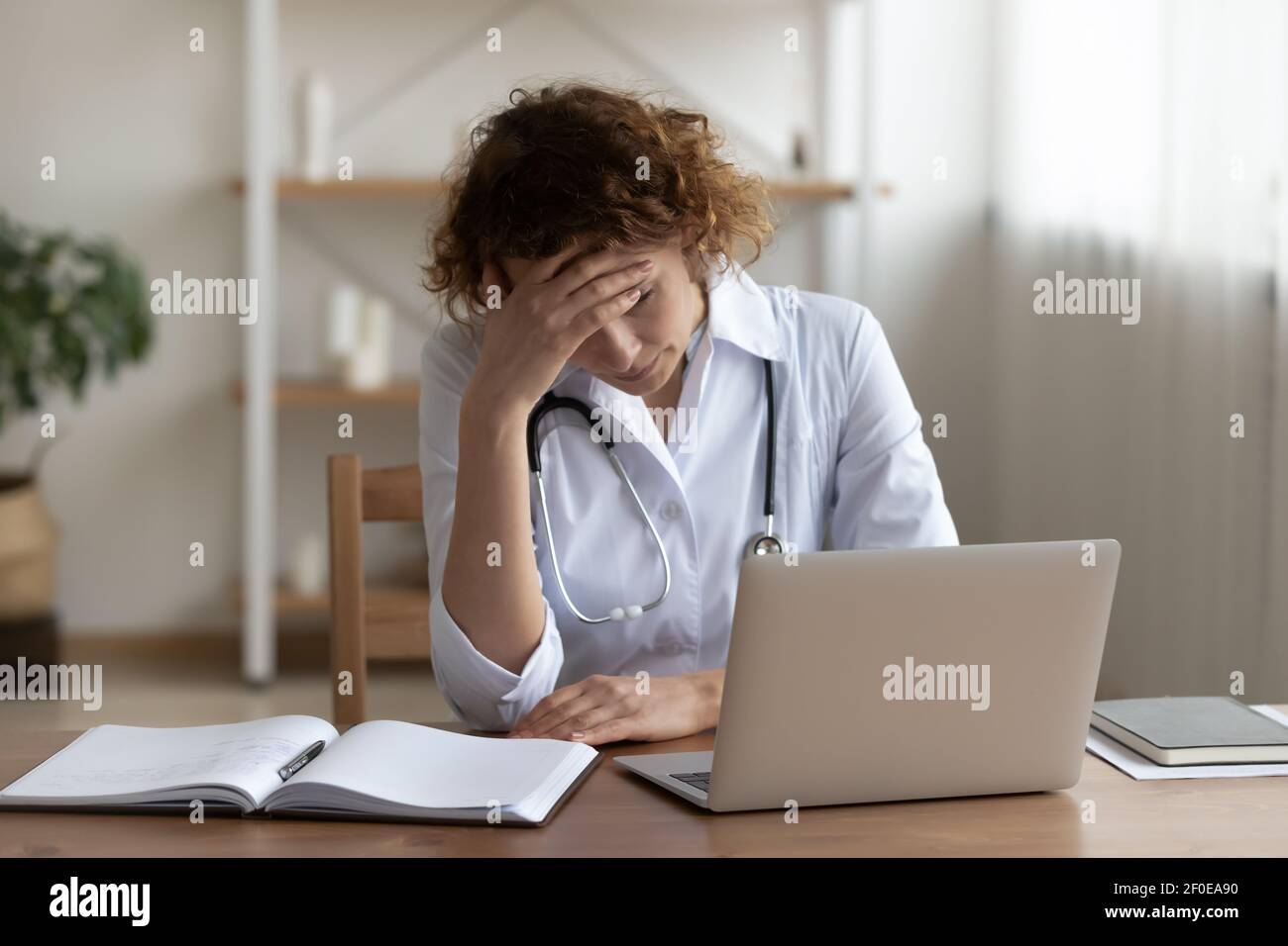 Unhappy female doctor frustrated by bad news on laptop Stock Photo - Alamy