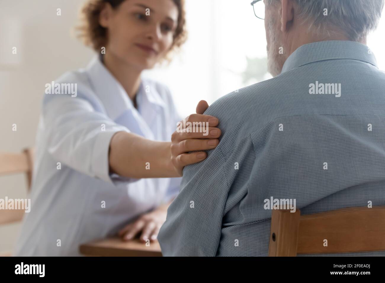 Supportive female doctor comfort elderly patient in hospital Stock ...