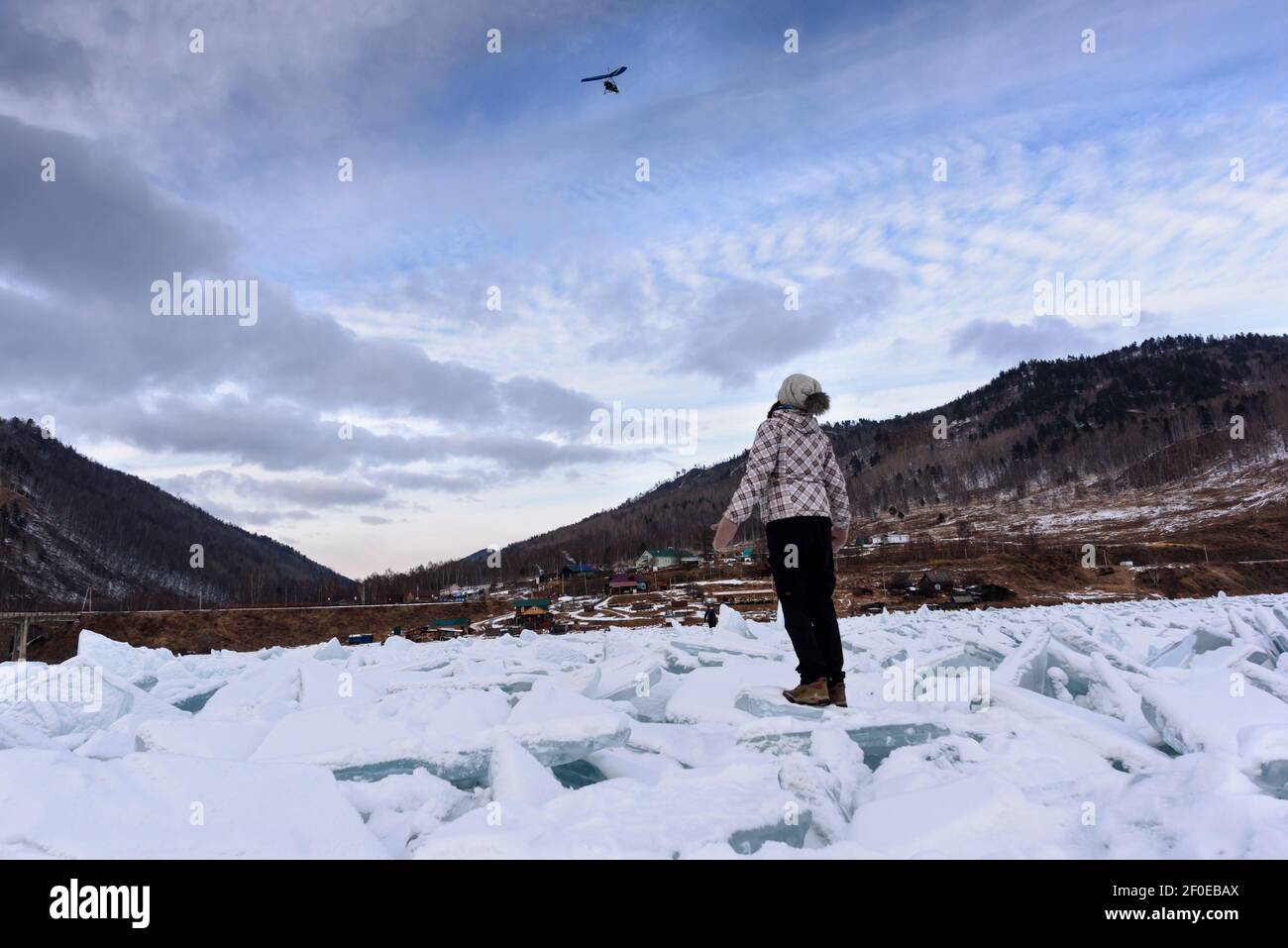 Silhouette of girl back view looking up at the sky on a flying ...