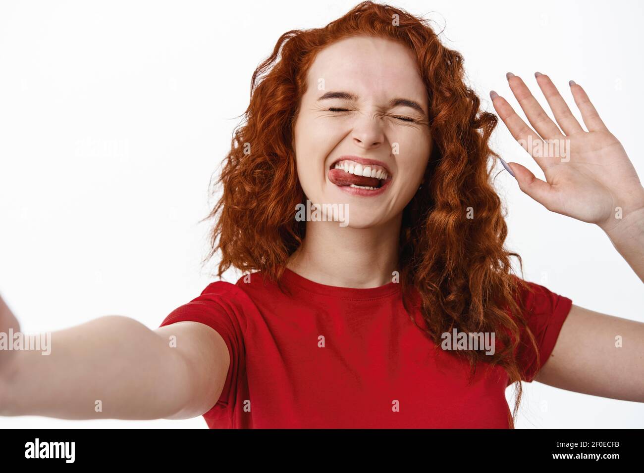 Close Up Portrait Of Happy Laughing Redhead Girl Waving Hand At