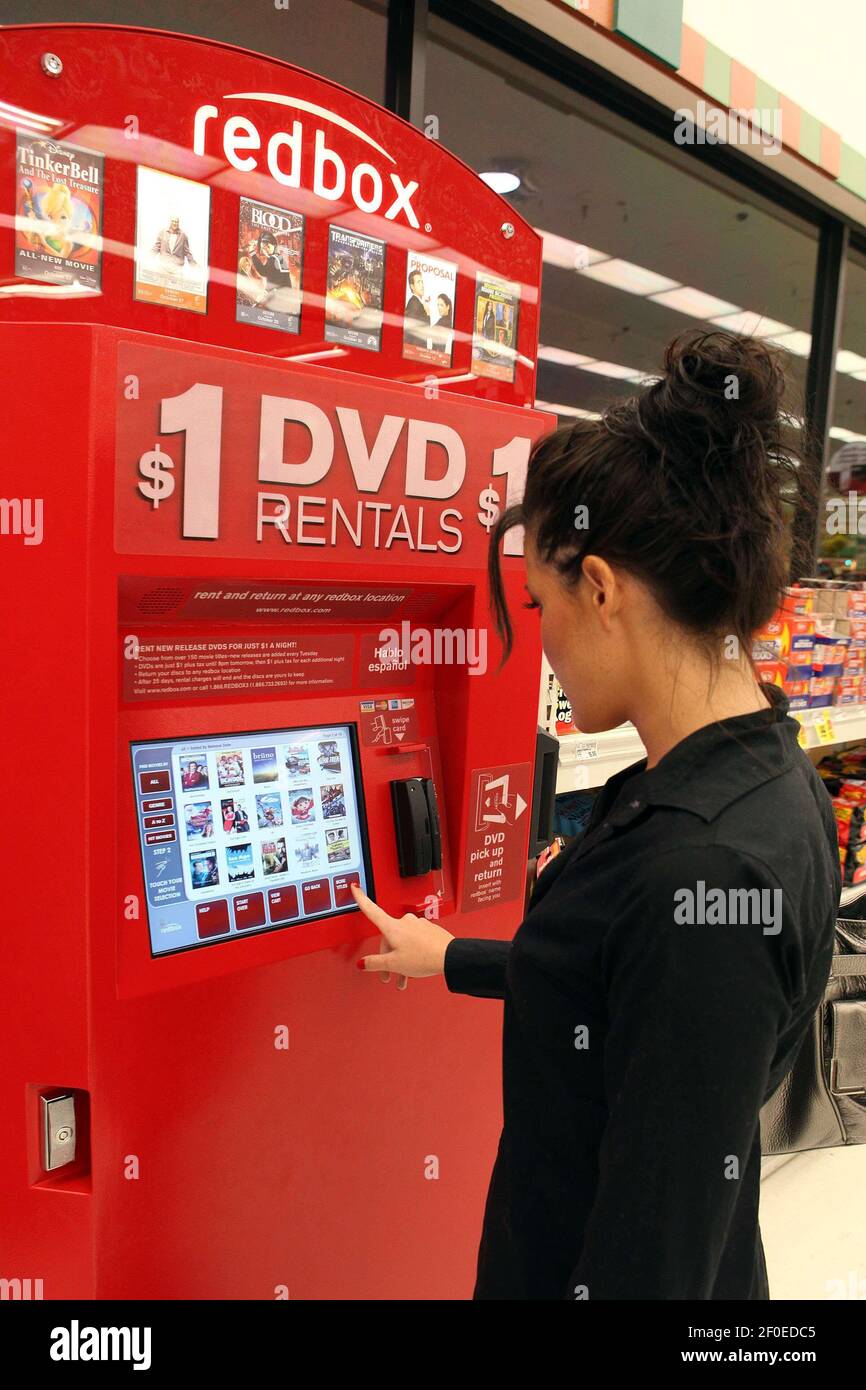 04 January 2010- Los Angeles, California- A woman rents DVDs at a Redbox kiosk located inside a ...