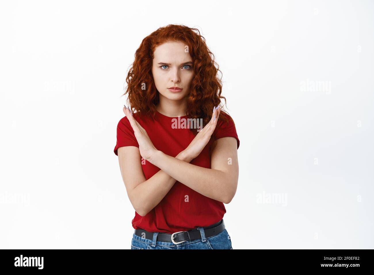 Serious ginger woman making cross stop gesture, say no, block and ...