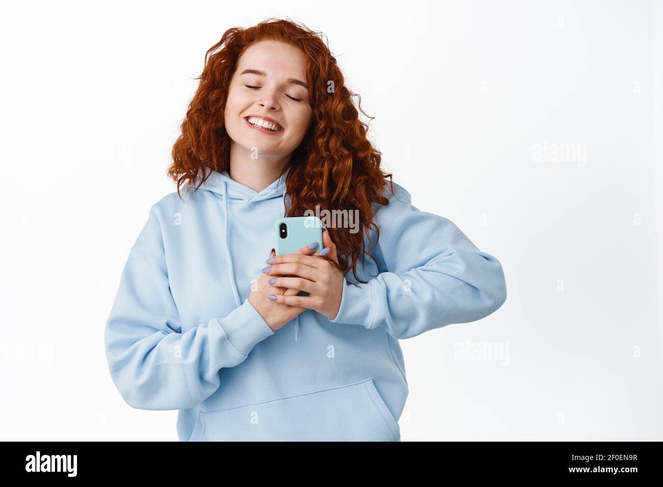 Portrait of romantic smiling girl with ginger curly hair, press ...