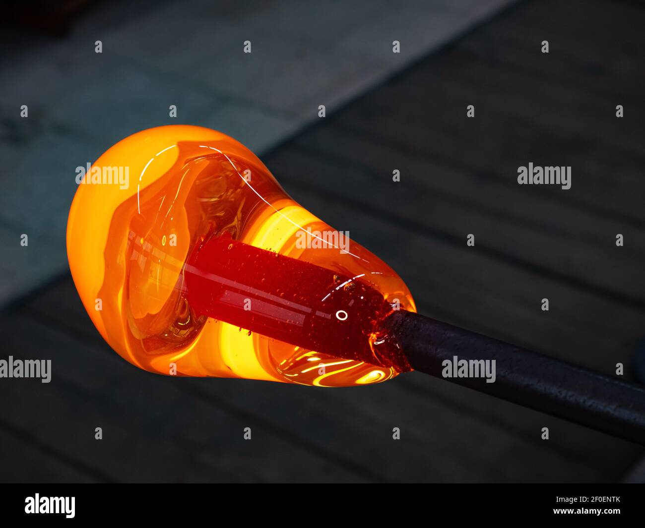 Heating piece of glass that skillfully hands and strong breath of the ...