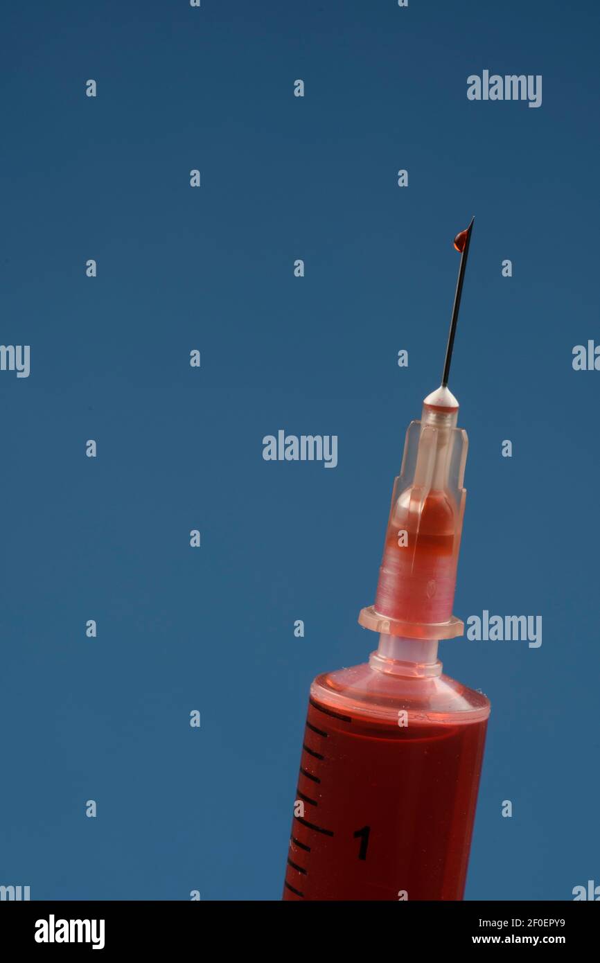 injection syringe with needle detail on colored background with space ...
