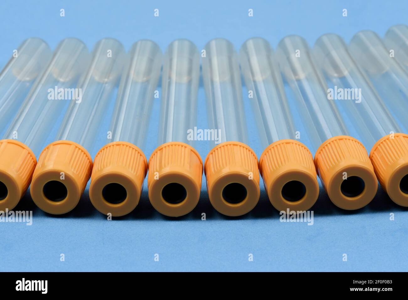 empty vacuum tube for blood collection on blue background Stock Photo ...