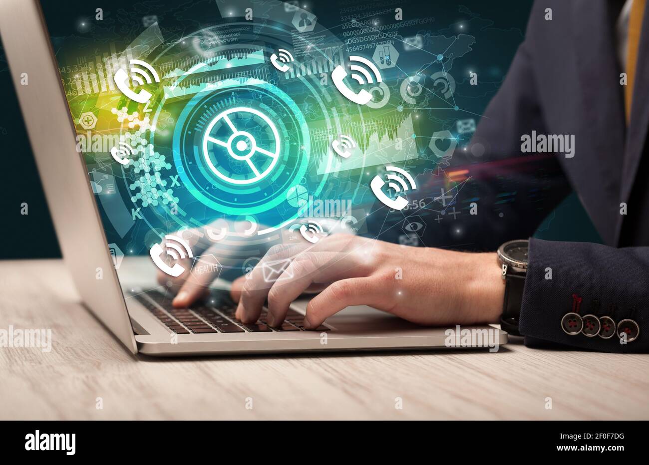 Business hand typing on a modern laptop with disk icon coming out from ...