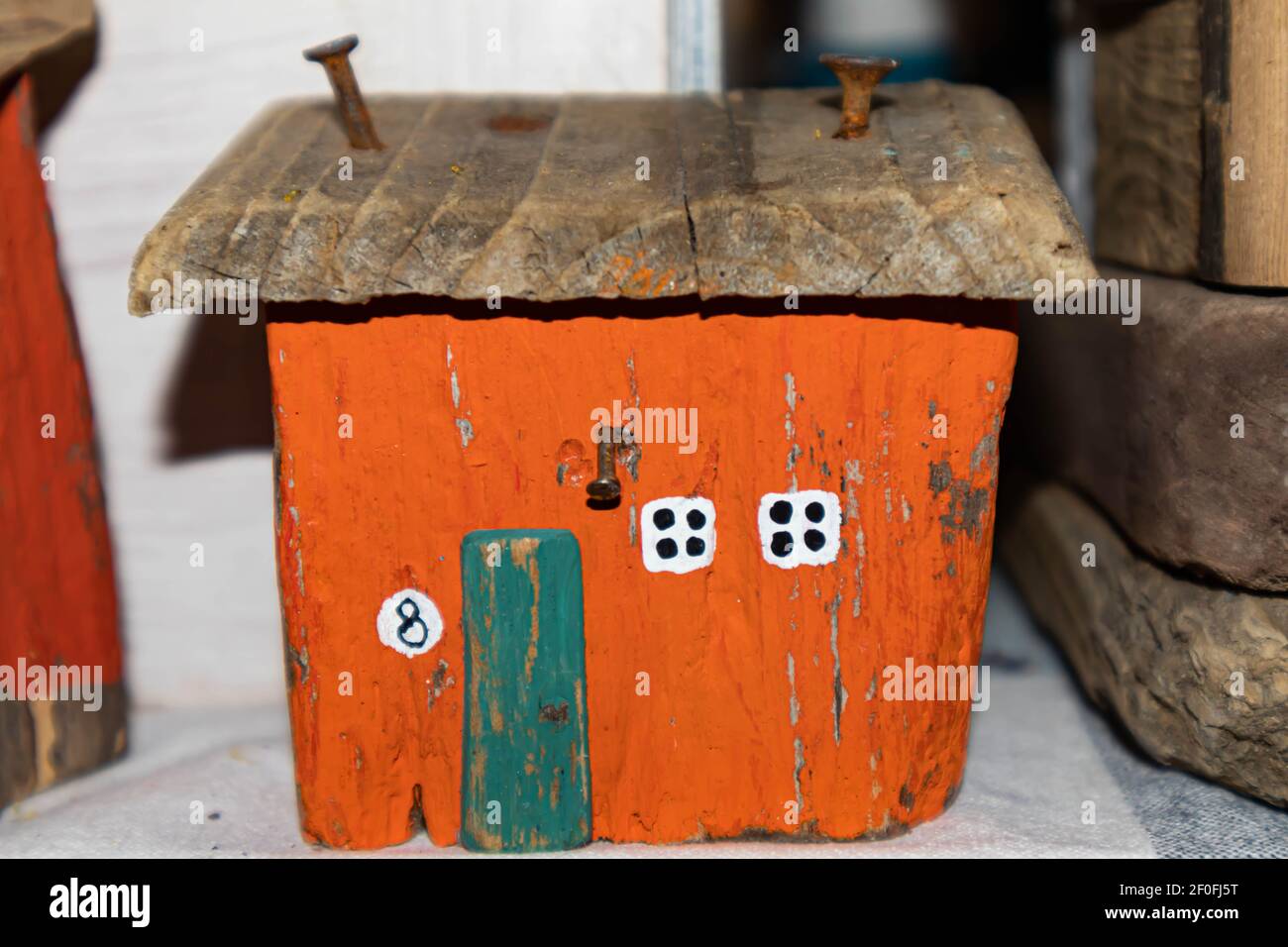 Old wooden orange house. Rusty nails are driven into the roof. Small ...