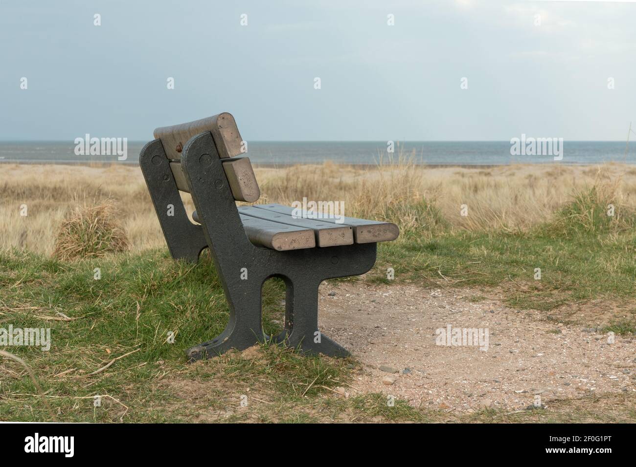 A colour photograph of a seat at the beach looking out over the sea ...