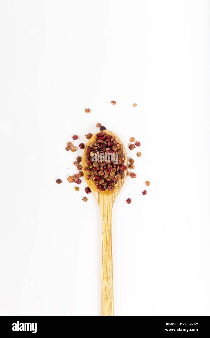 Whole Dried Sumac Berry Seeds (Rhus) in wooden spoon. Top View ...