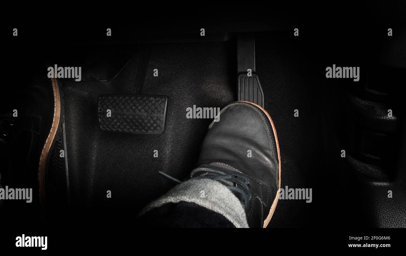 Accelerator and breaking pedal in a car. Close up the foot pressing ...