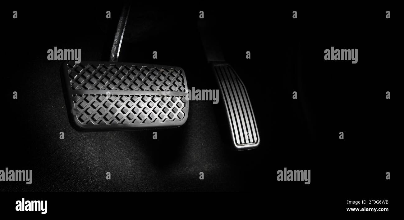 Accelerator and breaking pedal in a car. Close up the foot pressing ...